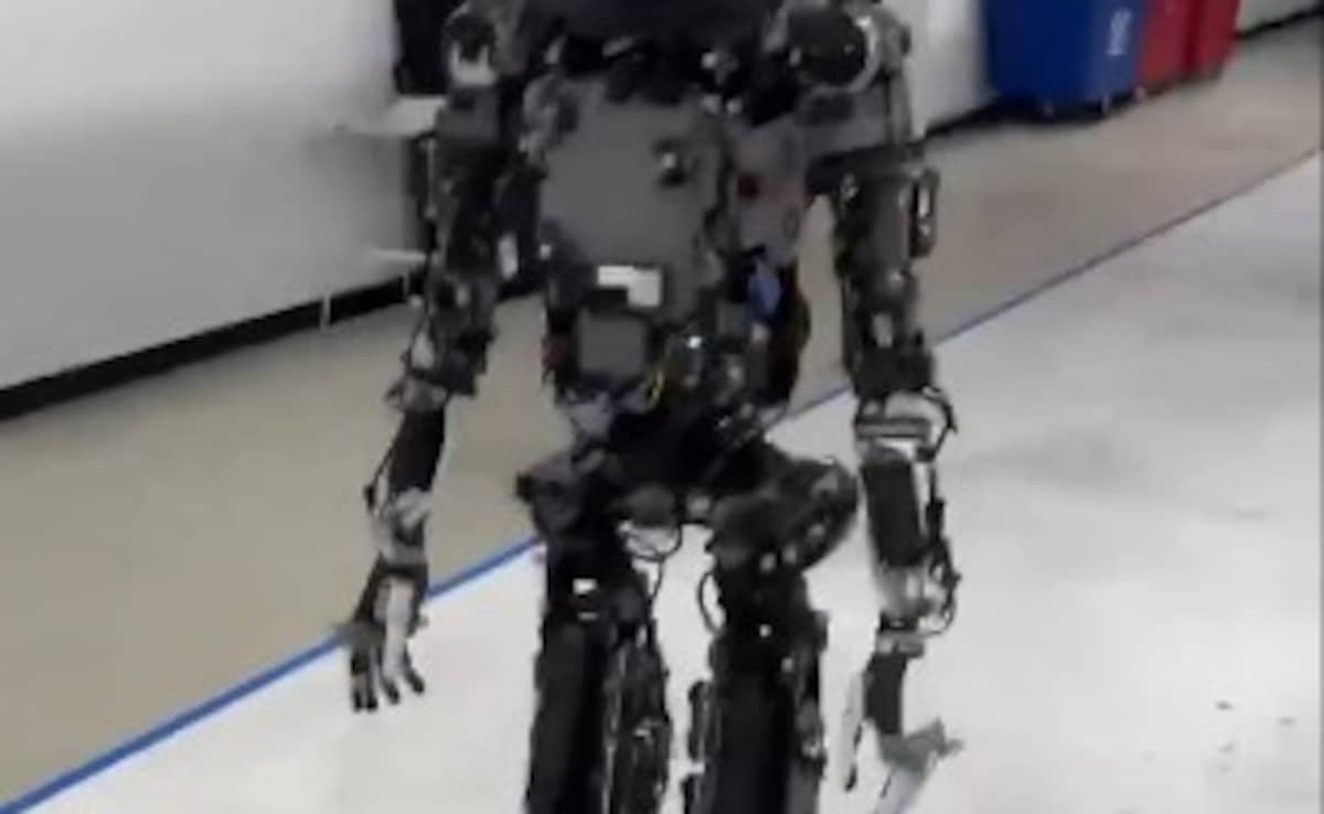 Video: Tesla's Optimus Robot Goes For A Walk With Elon Musk