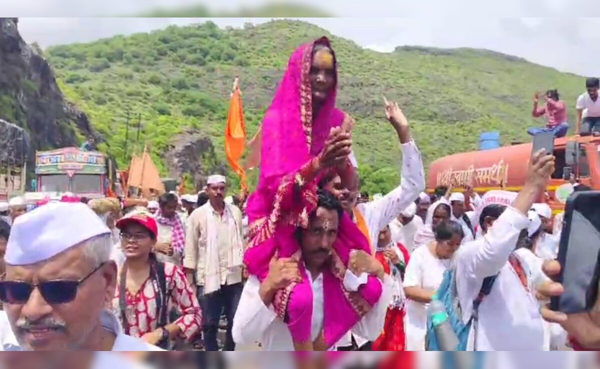 Pandhari vari Sundarabai Dhumal going on her grandson shoulder