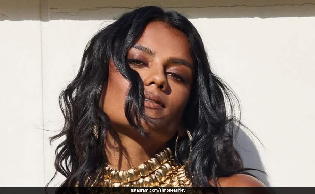 Simone Ashley Embraces The Gold Charm In A Gilded Balmain Gown At F1 ...